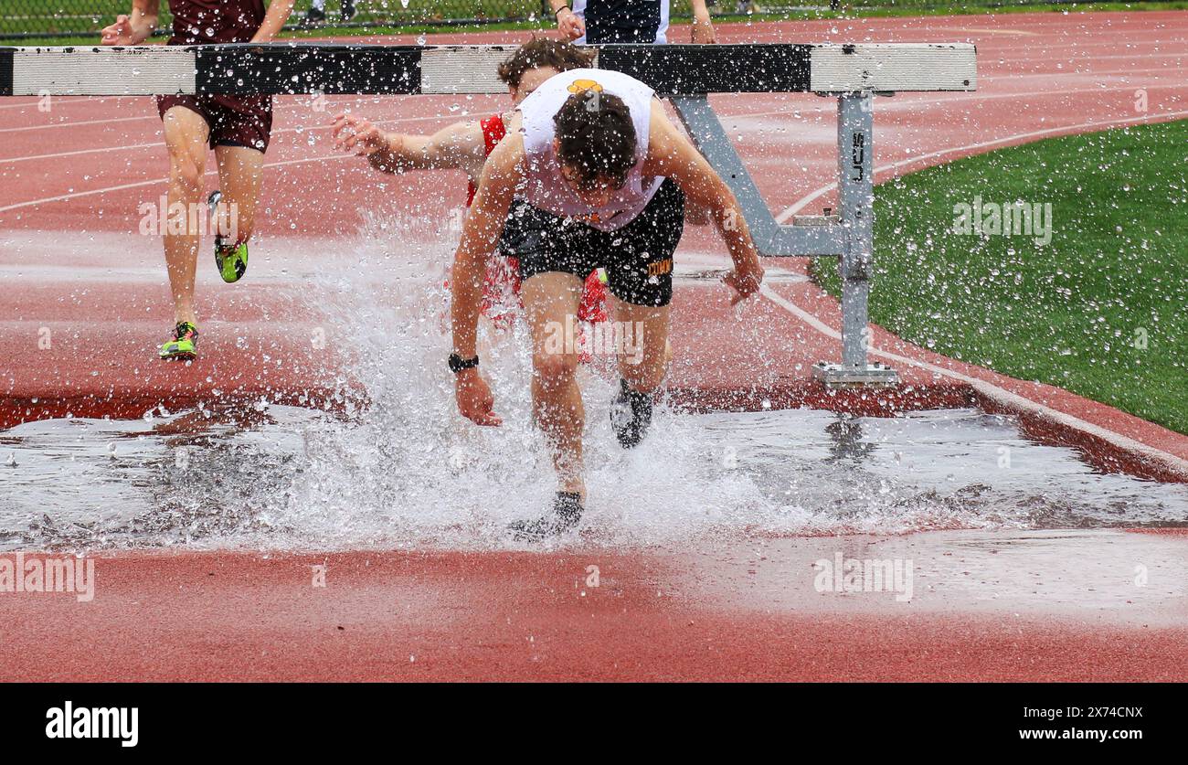 Close up of Runners splashing and falling in the water during a track ...