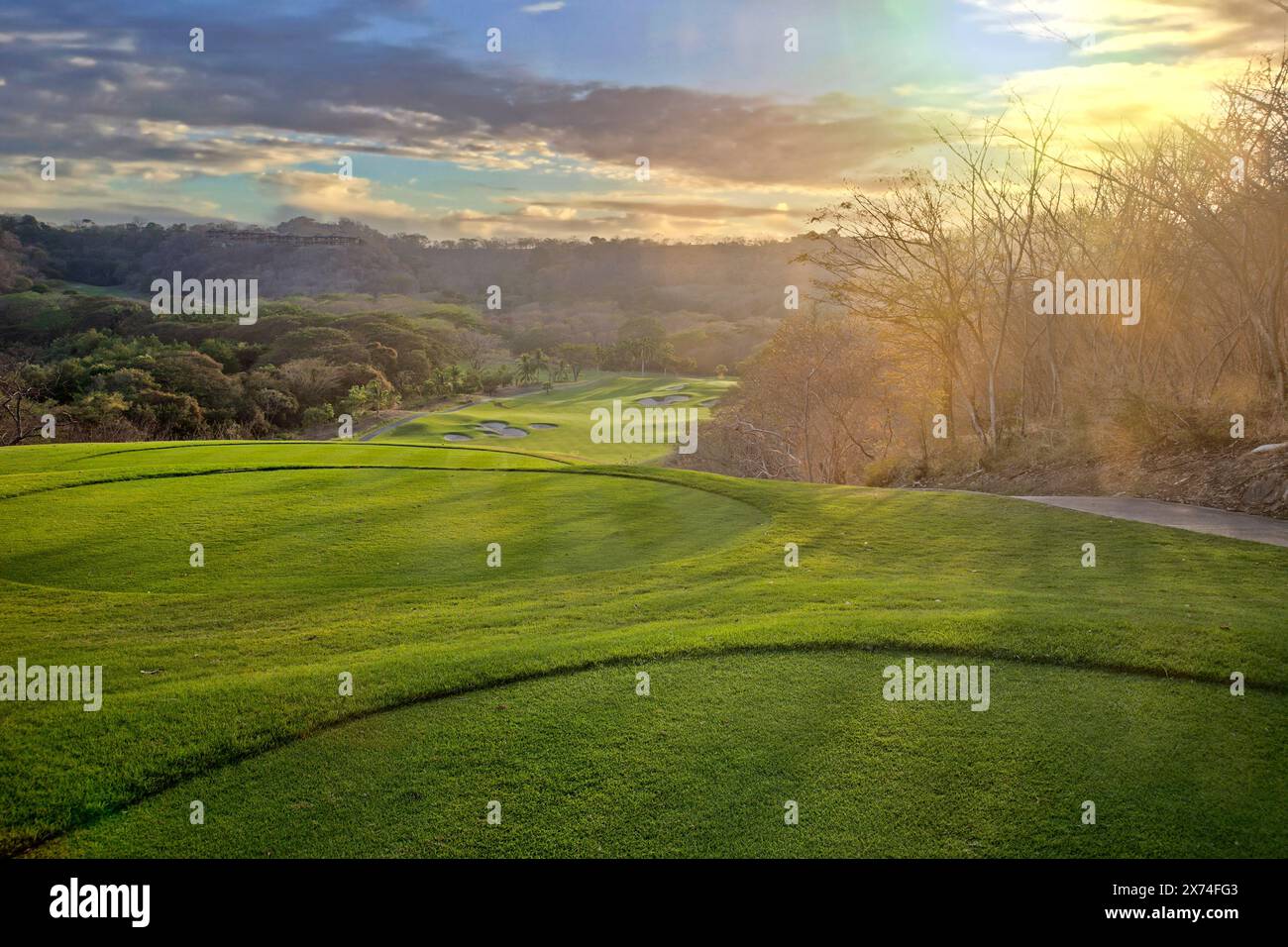 Bright sun setting over a hilly landscape in tropical Costa Rica Stock ...