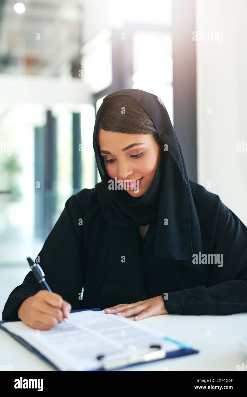 Employee, documents and Muslim woman writing, contract and planning ...