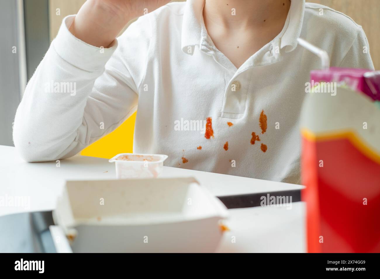 Dirty ketchup stains on white clothes. Kids eat unhealthy fat food ...
