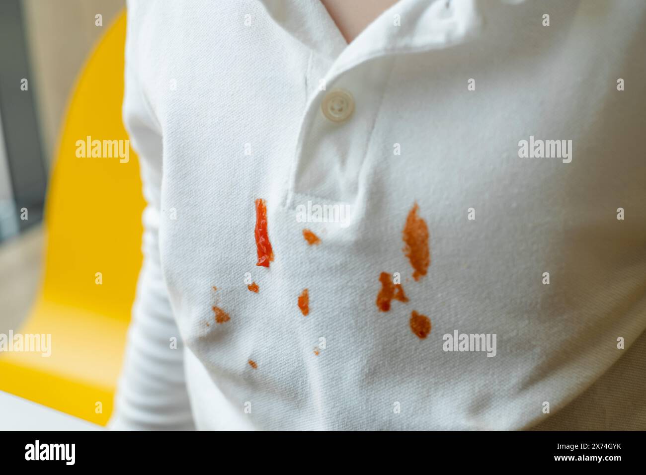 Dirty ketchup stains on white clothes. Kids eat unhealthy fat food ...