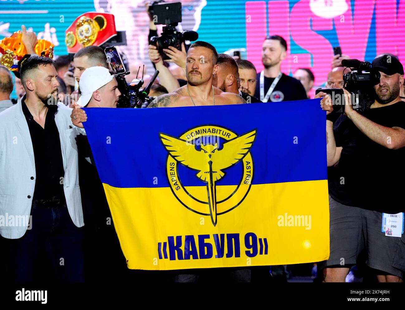 Oleksandr Usyk holds up the Flag of Ukraine during a weigh-in at BLVD ...
