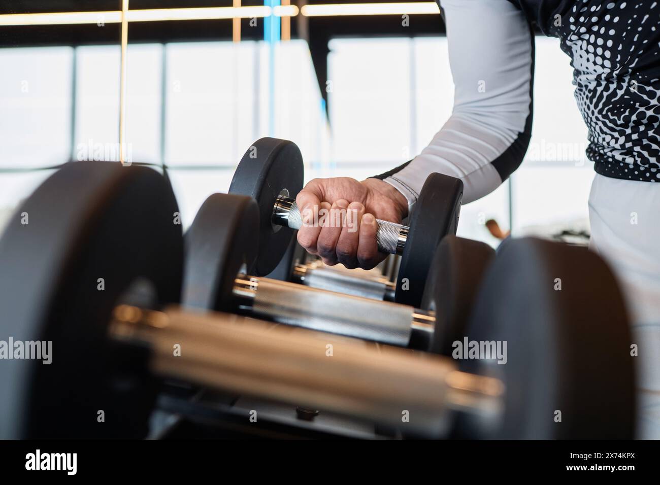 Side view closeup of muscular male hand lifting heavy dumbbell off ...