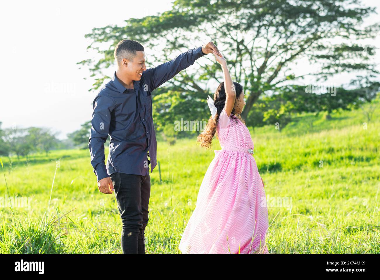 Latin Father Holding His Daughters Hand While She Dances Standing On