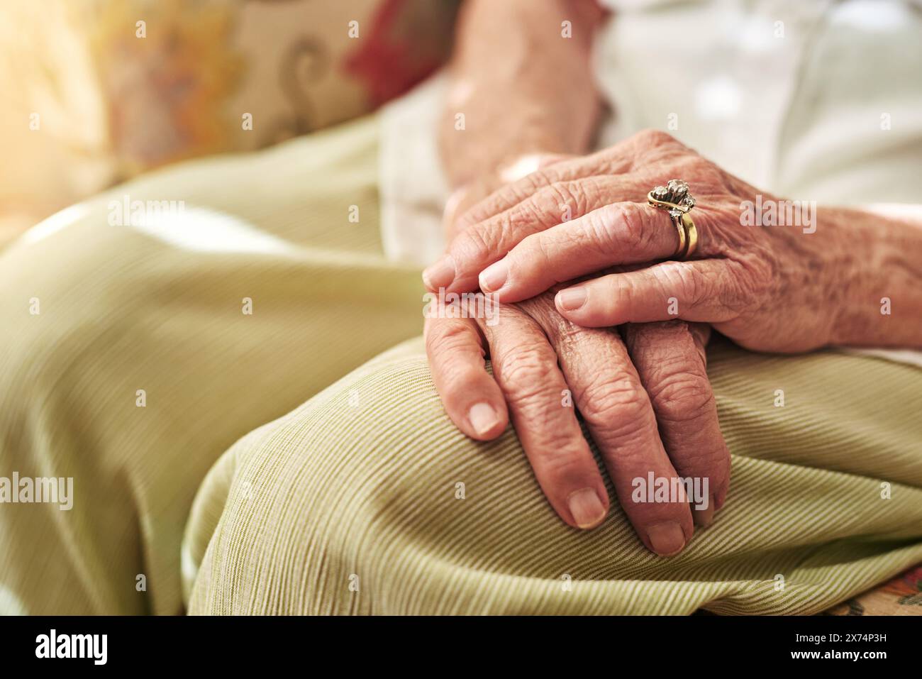 Closeup, sofa and hands of elderly woman in retirement home for ...