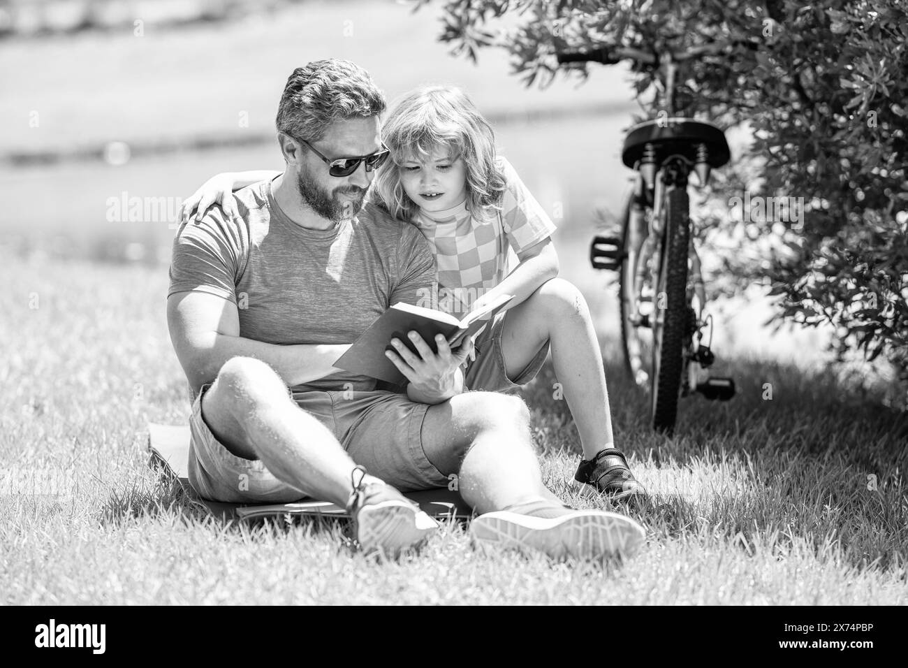 child son learning with dad outdoor. Father and son bonding through ...