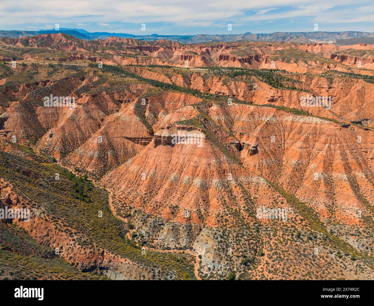 Impressive red rocks and canyons in a hilly desert landscape under a ...