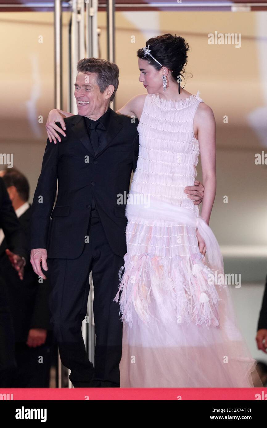 Willem Dafoe, left, and Margaret Qualley pose for photographers upon departure from the premiere ...
