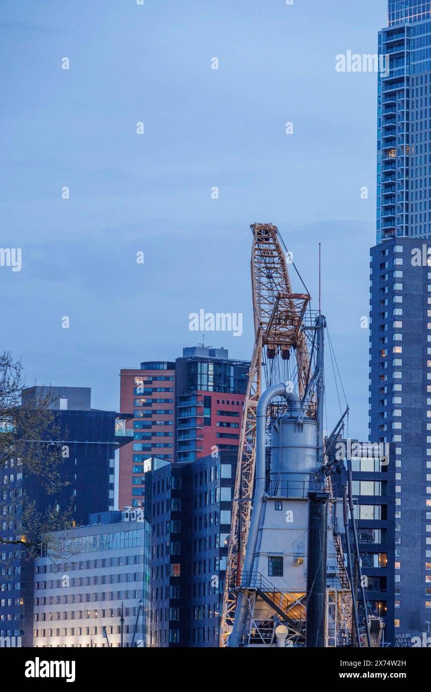 A construction crane in front of skyscrapers in a modern cityscape ...
