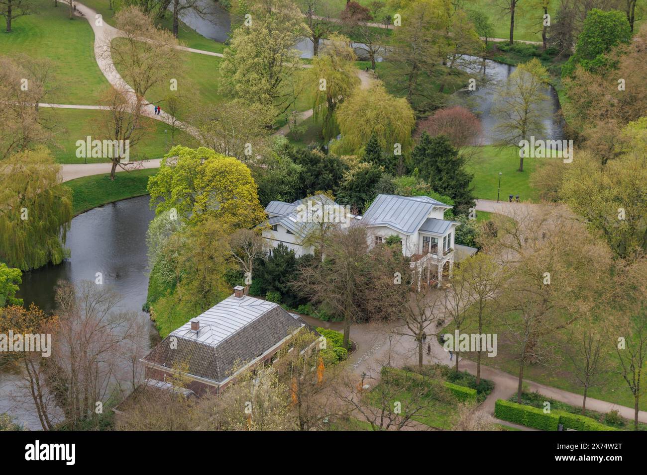 A dreamy picture of a park with buildings and a pond, surrounded by ...