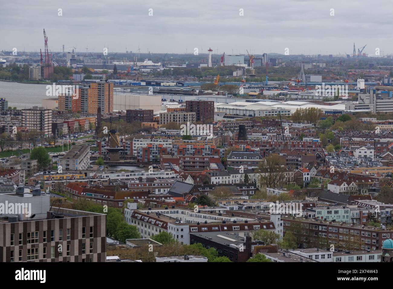 View of a district with harbour facilities, buildings and streets under ...