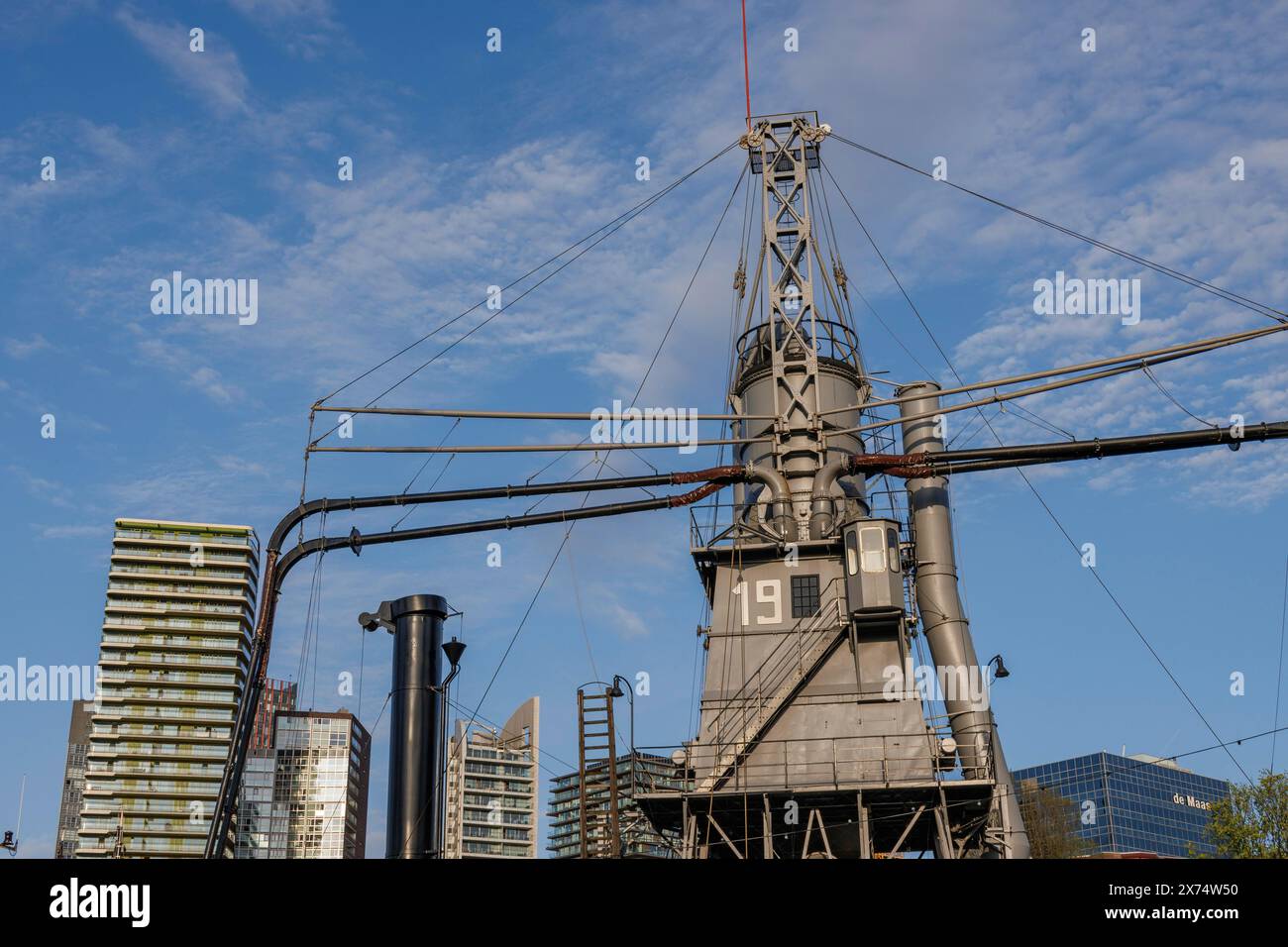 An industrial structure standing in front of modern skyscrapers and a ...