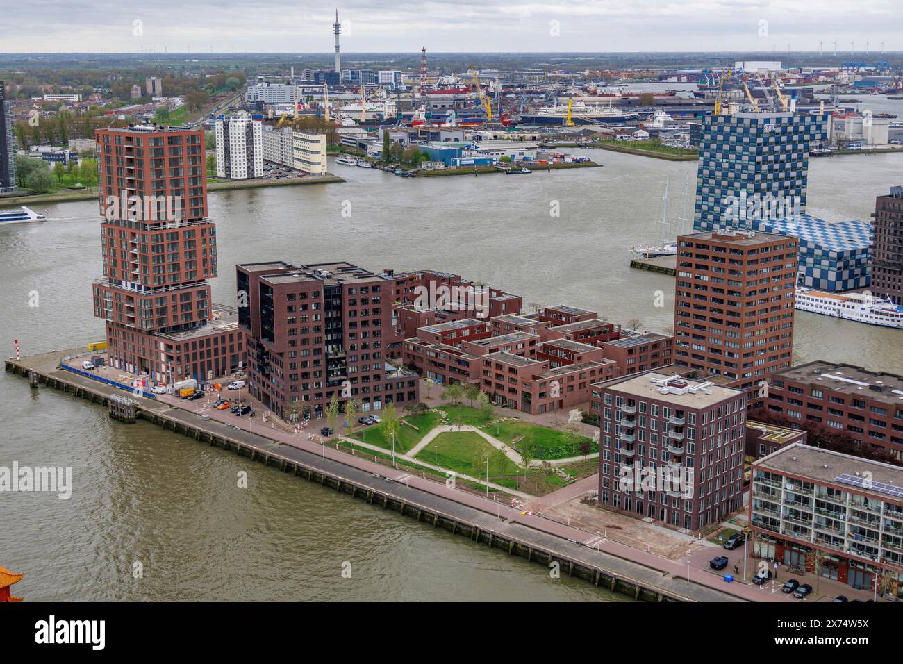 Modern skyscrapers and residential complexes along a river under a ...