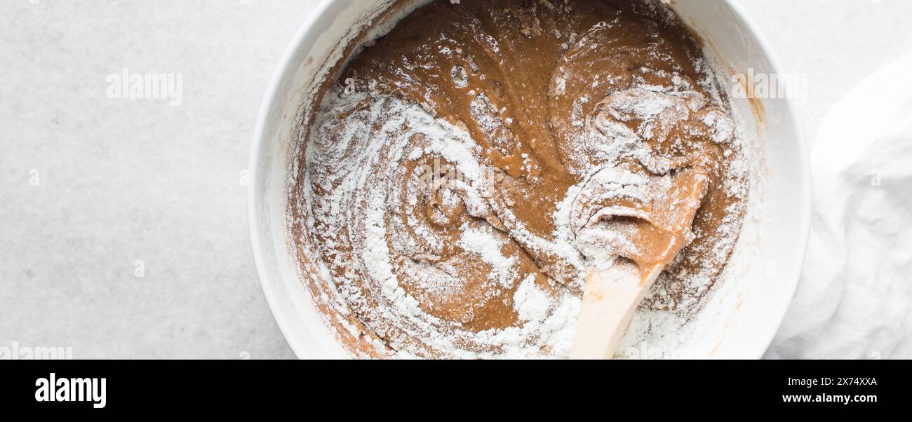 Flour being folded into sugar cookie dough, process of making sugar ...