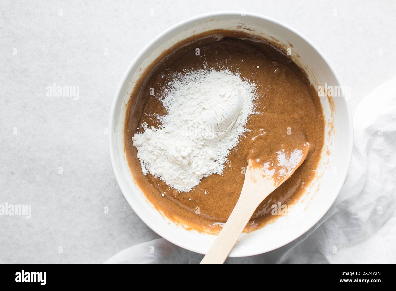 Flour being folded into sugar cookie dough, process of making sugar ...
