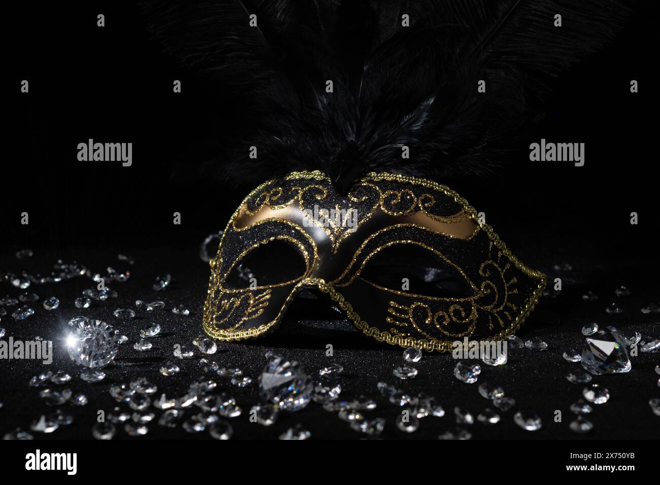 Masquerade gold mask with gemstones on black background Stock Photo - Alamy