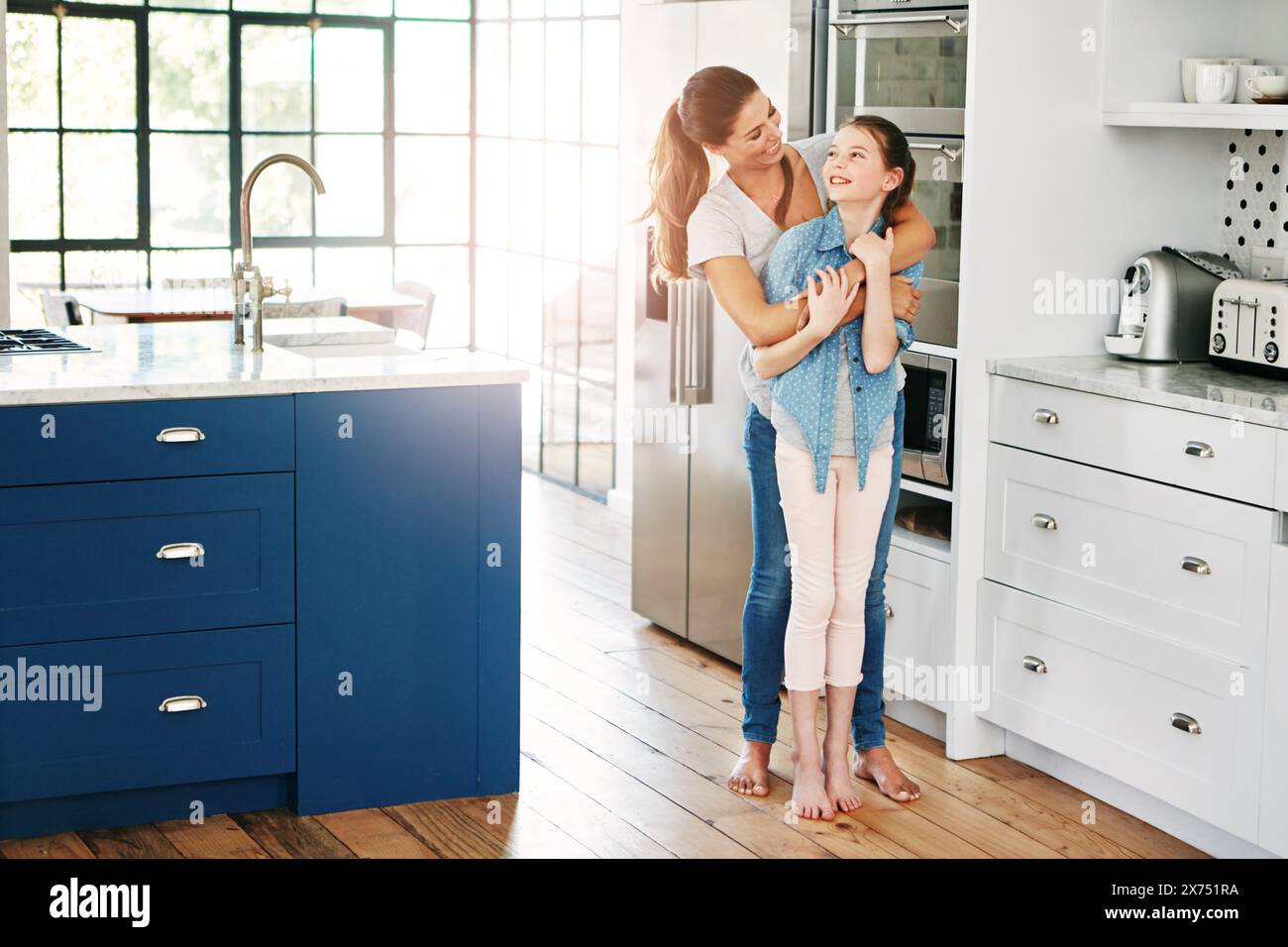 Woman, smile and kid with hug in family home for connection, care and bonding together in ...