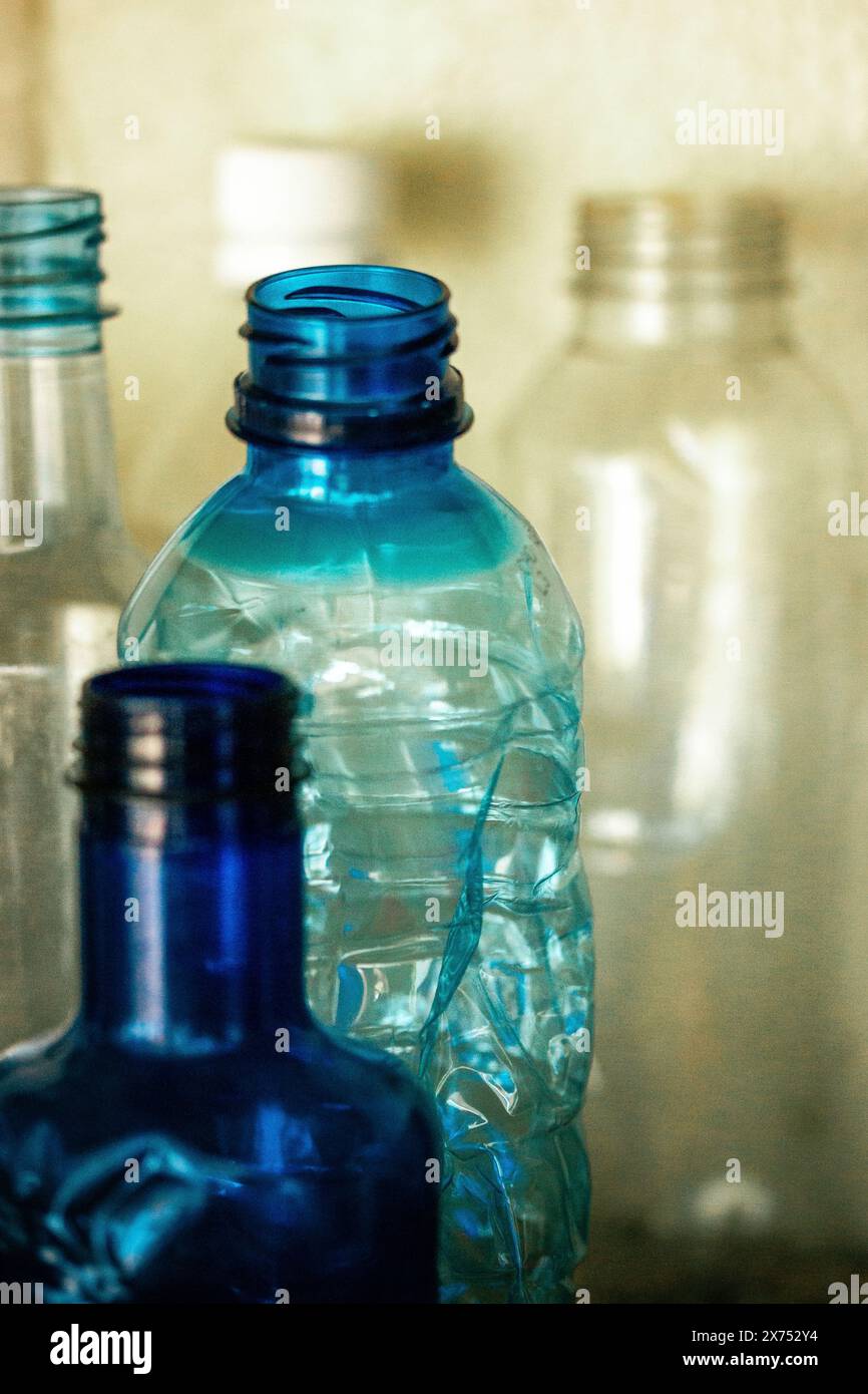 Collection of blue plastic water bottles on blurred background ...