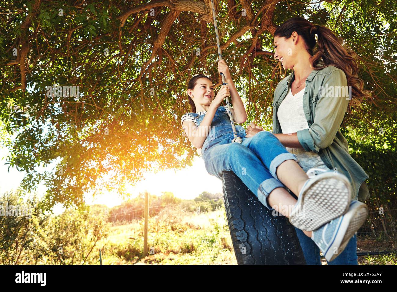 Smile, mother and child on tire swing outdoor for bonding and play fun ...