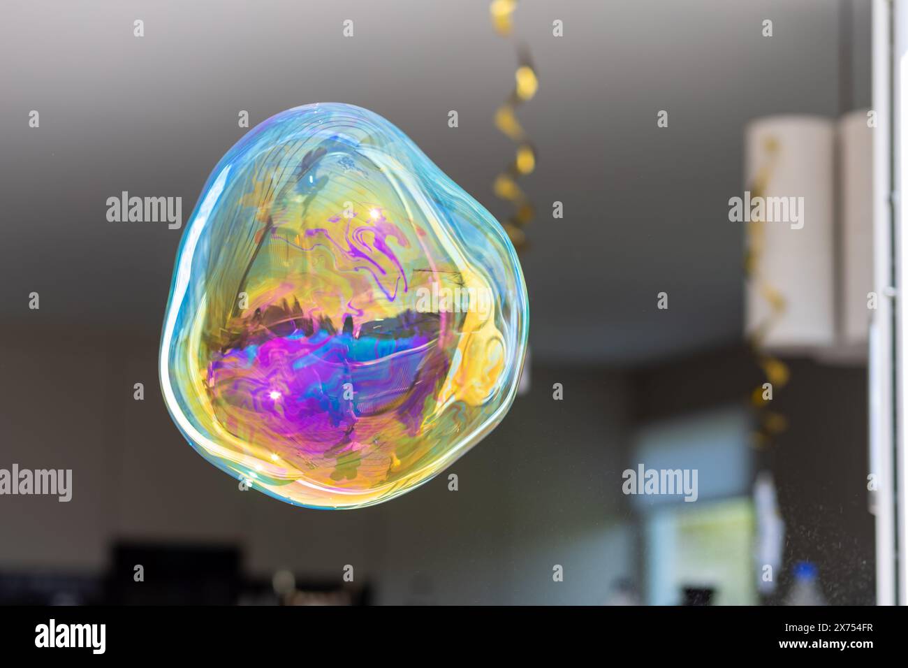 A colourful soap bubble floating in mid-air Stock Photo - Alamy