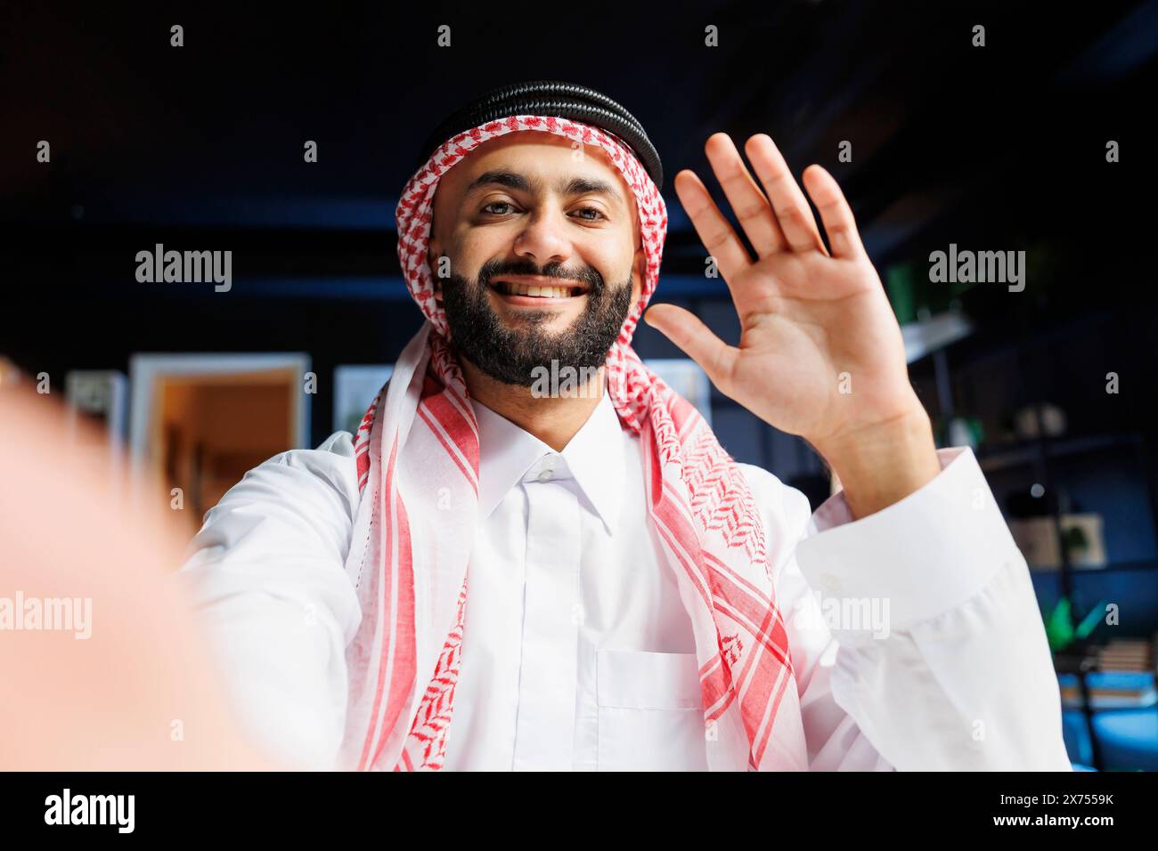 POV of a cheerful Muslim guy dressed in traditional clothing, engaging ...