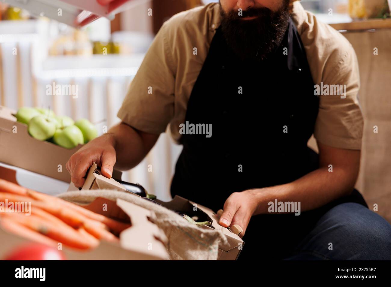 Green living merchant adding crates full of vegetables from his own ...