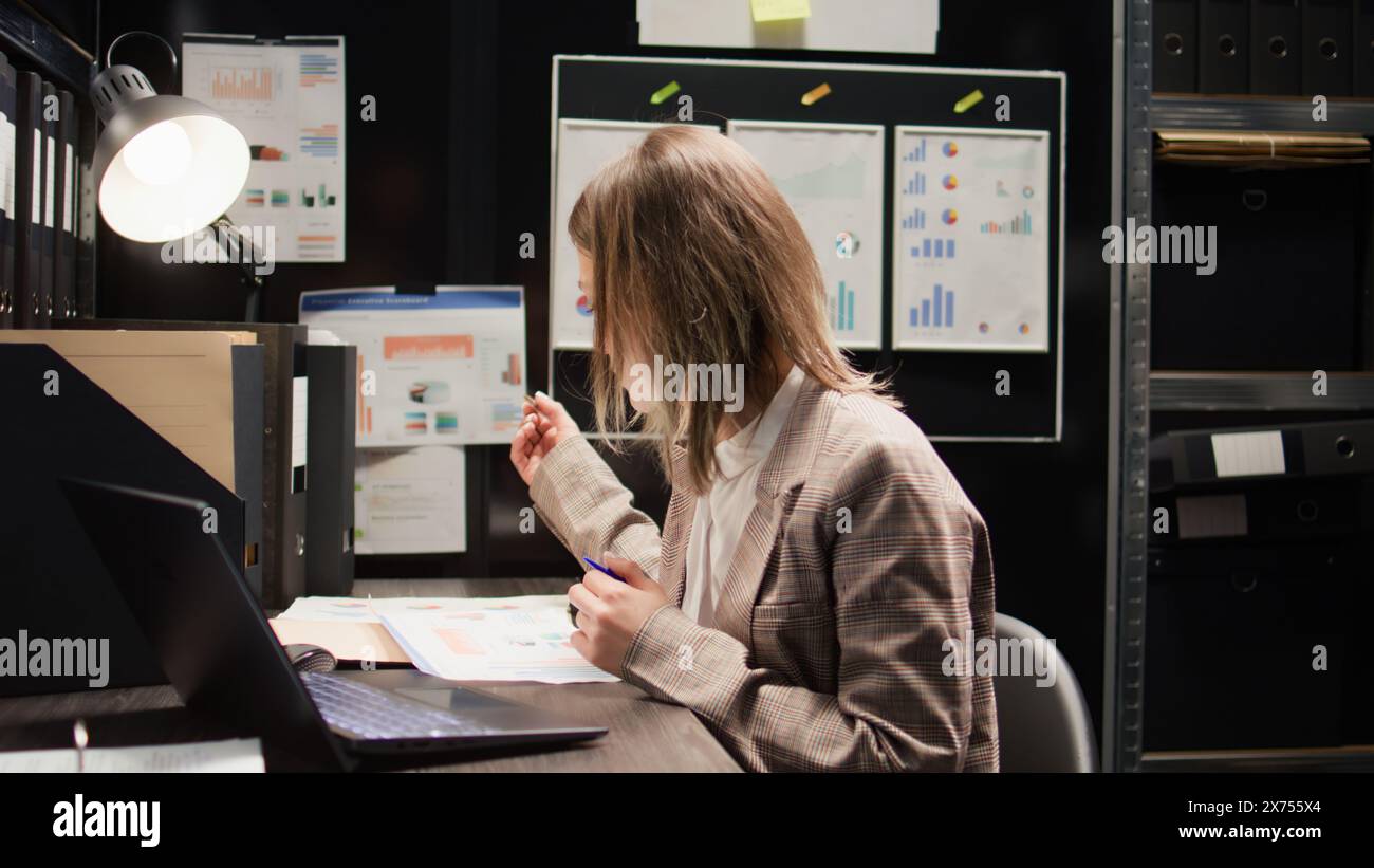 In criminal investigation office, dedicated caucasian policewoman ...