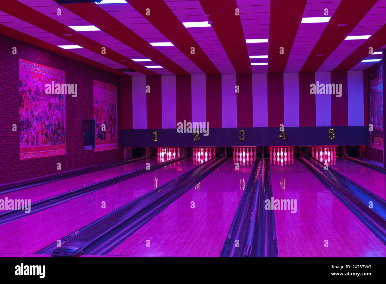 View Of Bowling Alley Interior With Pins Set Up And Five Lanes Under Illuminated Lighting