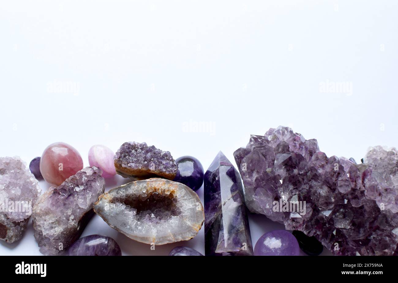 Beautiful druses of natural purple mineral amethyst on a white ...