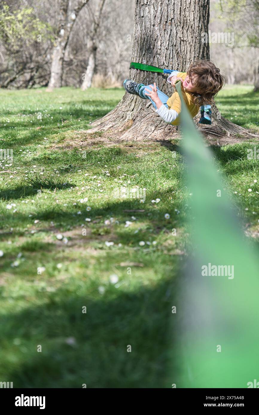 A Child falling while trying to walk on slackline Stock Photo - Alamy