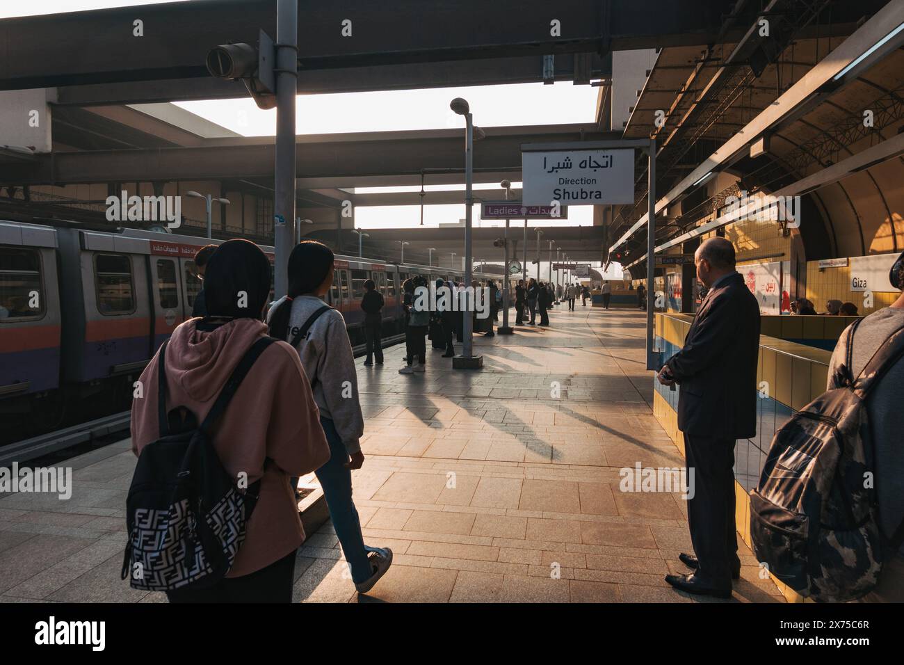 Commuters on a platform at Giza station on the Cairo Metro Line 2 ...