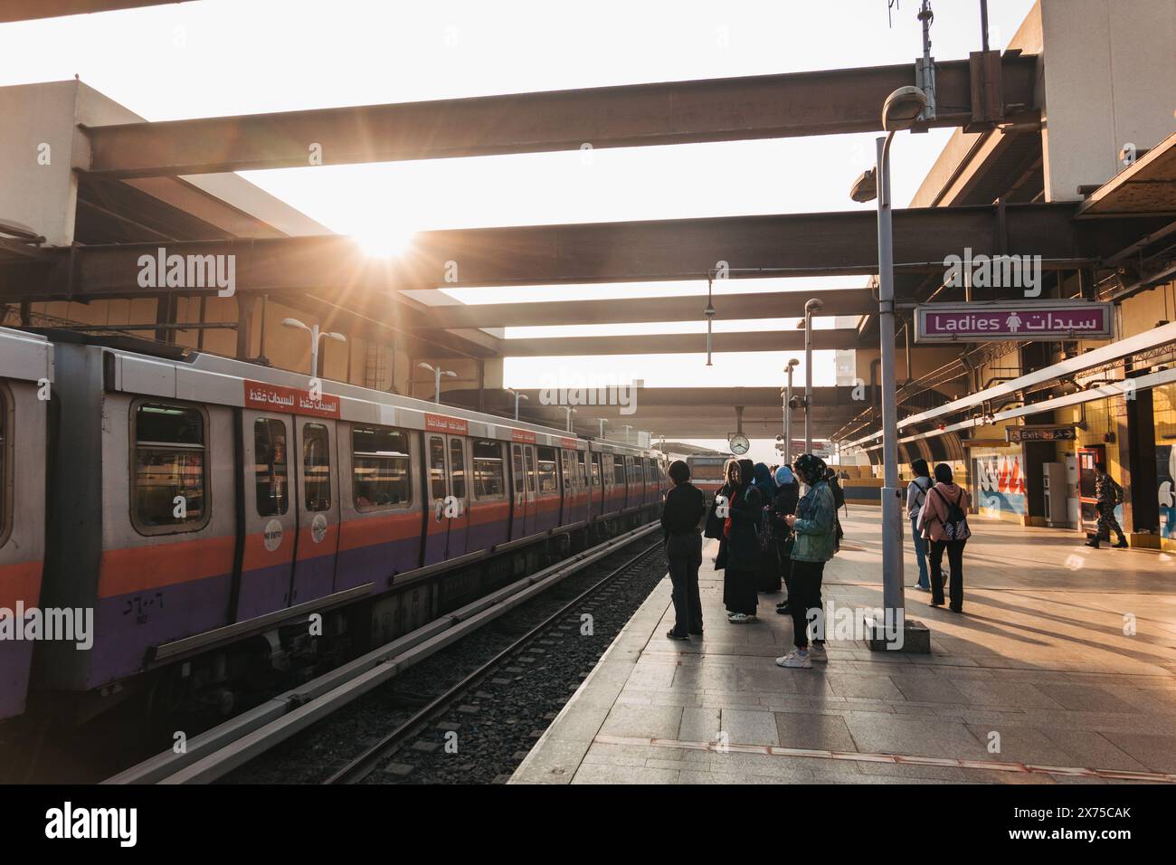 Commuters on a platform at Giza station on the Cairo Metro Line 2 ...
