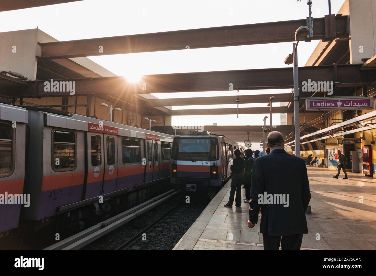 Commuters on a platform at Giza station on the Cairo Metro Line 2 ...