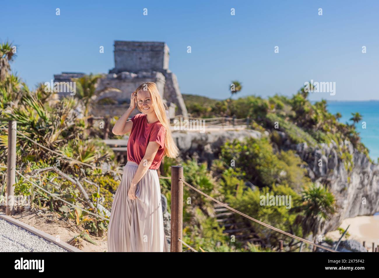 Woman tourist enjoying the view Pre-Columbian Mayan walled city of ...