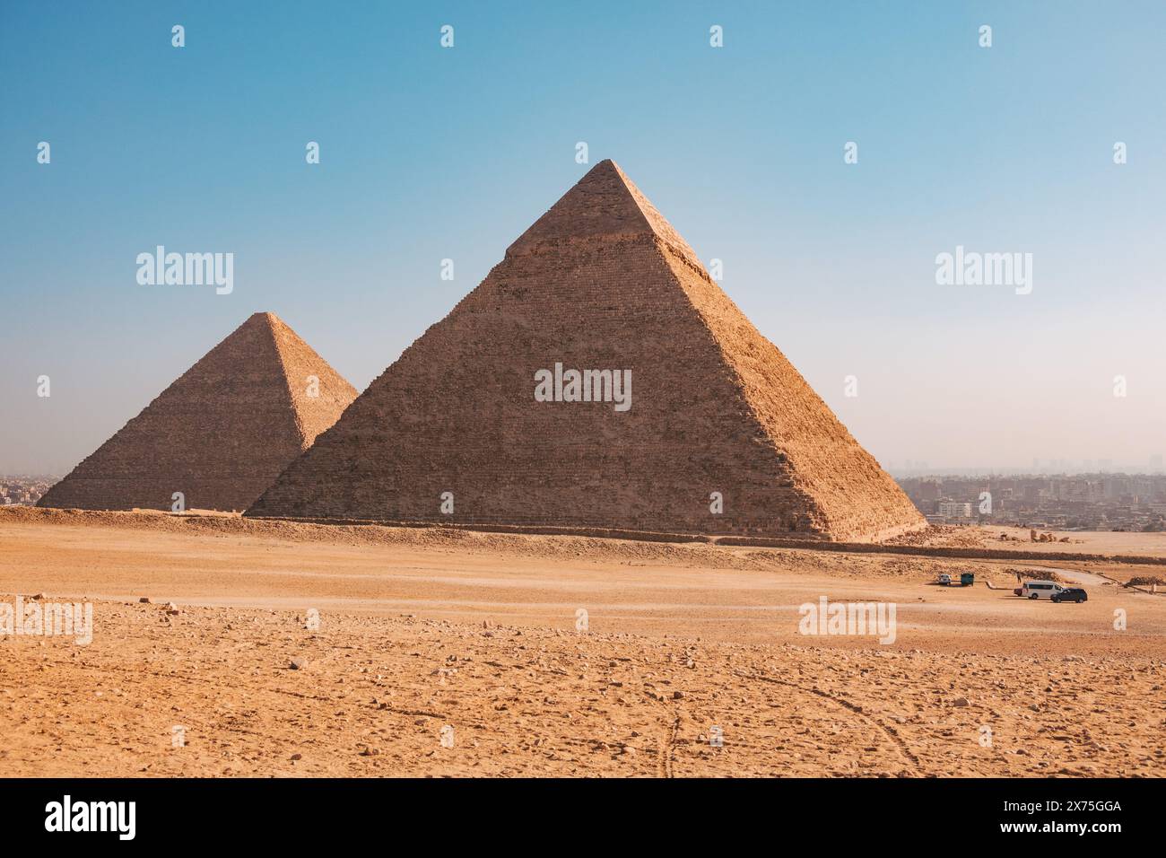 The Pyramids of Khafre and Menkaure rise from the Giza Plateau under ...