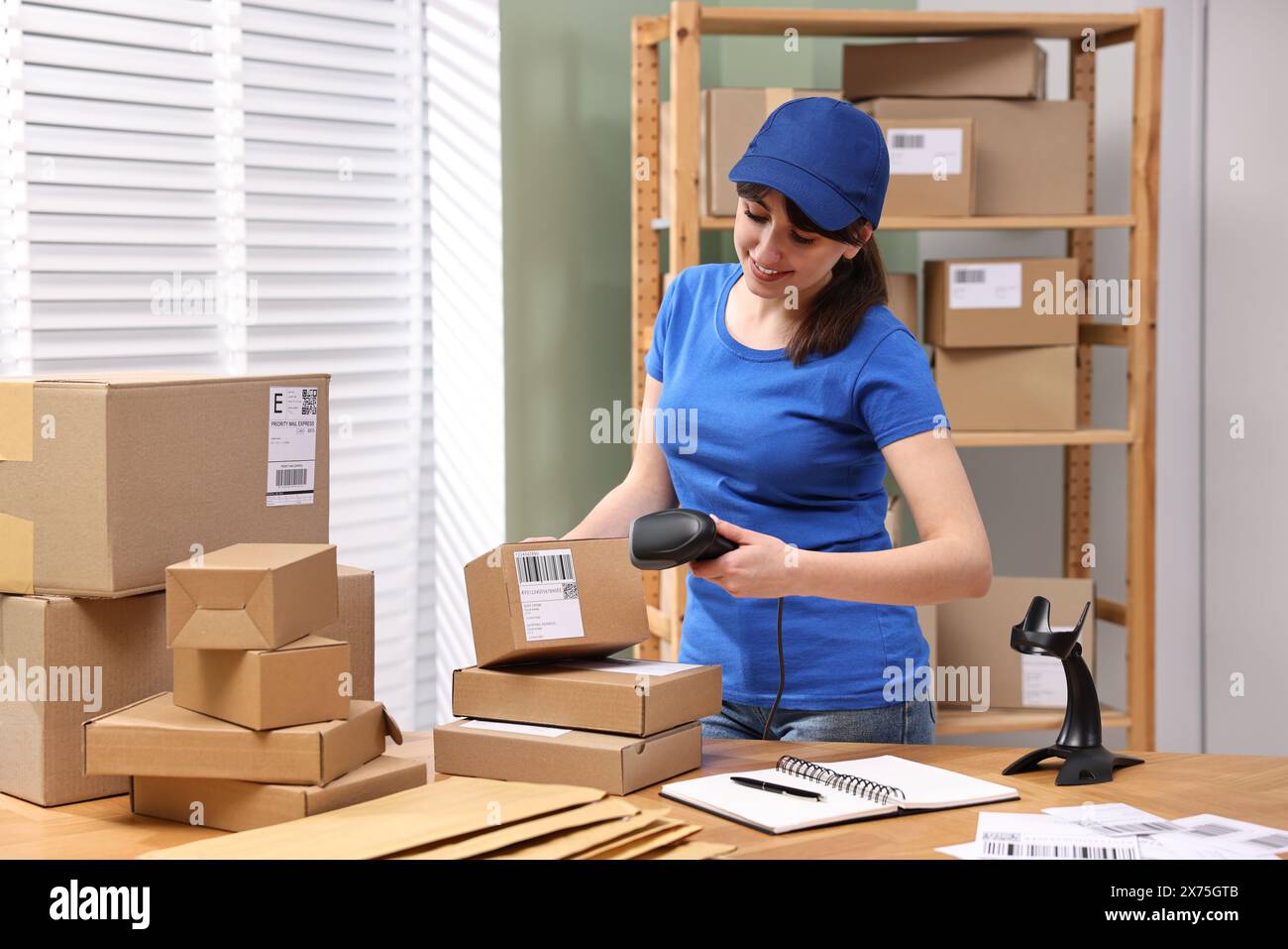 Woman scanner reading parcel hi-res stock photography and images - Alamy