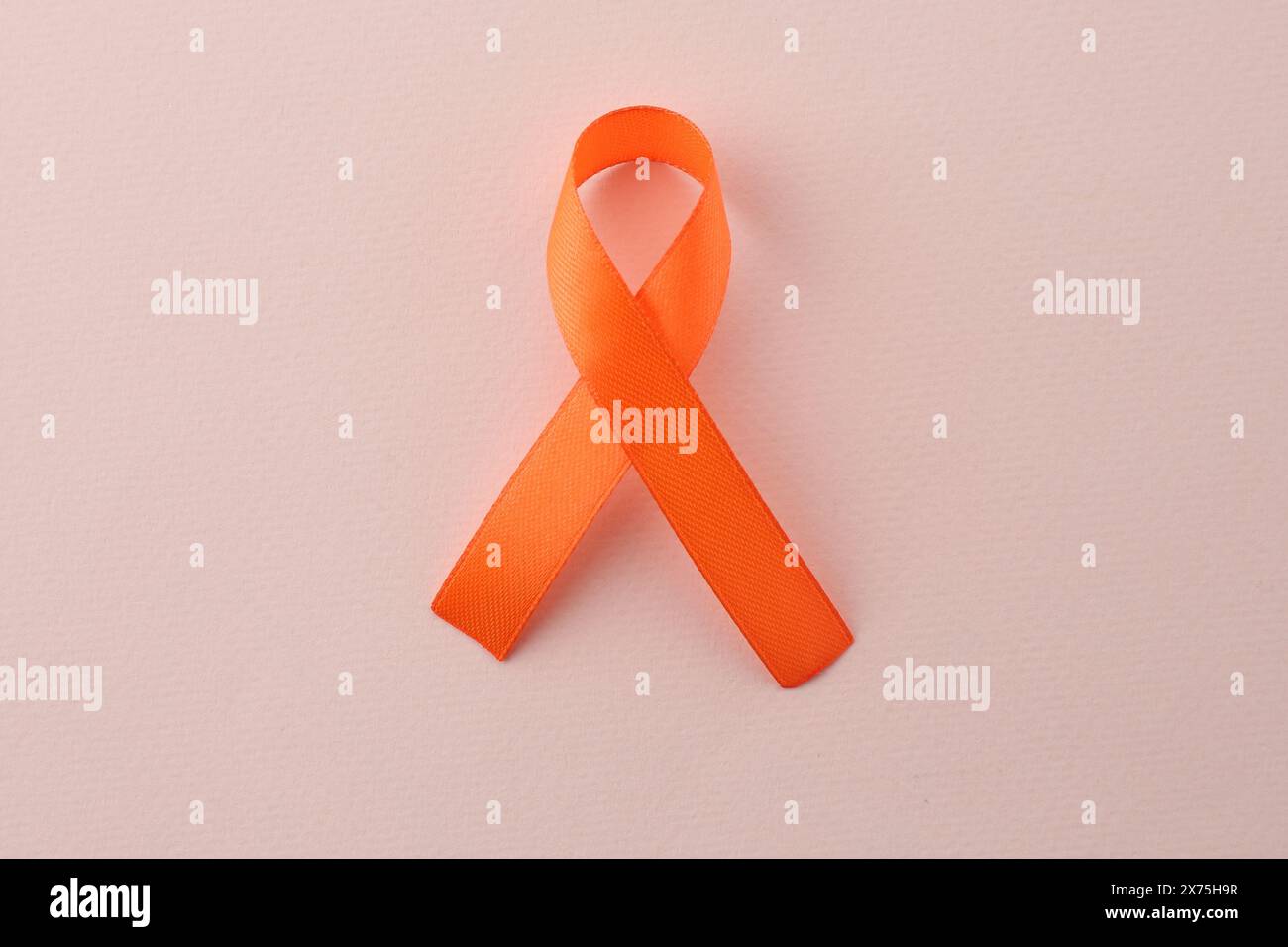 Orange awareness ribbon on beige background, top view Stock Photo - Alamy
