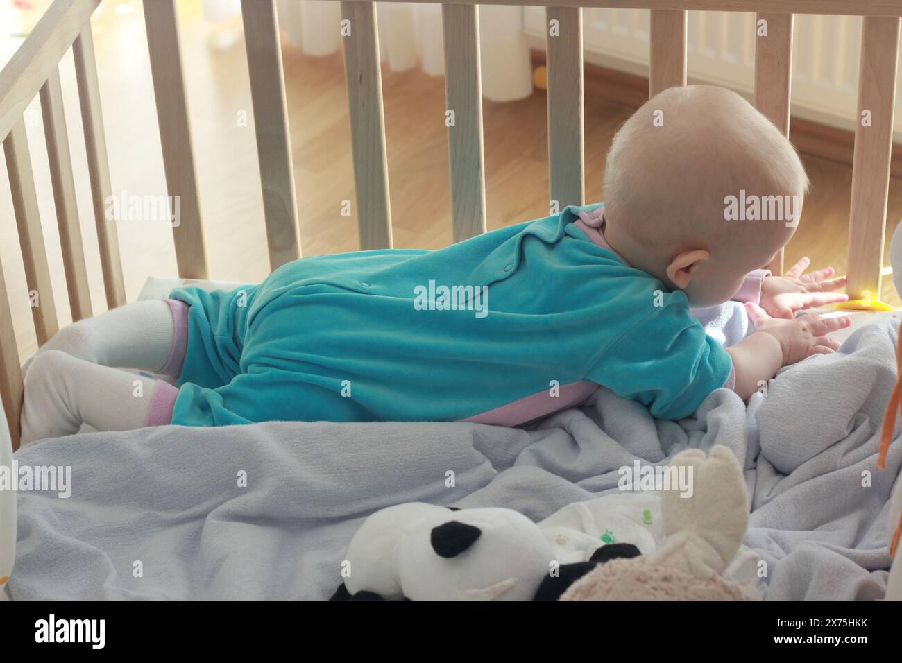 Little Baby Boy In A Wooden Cot Stock Photo - Alamy