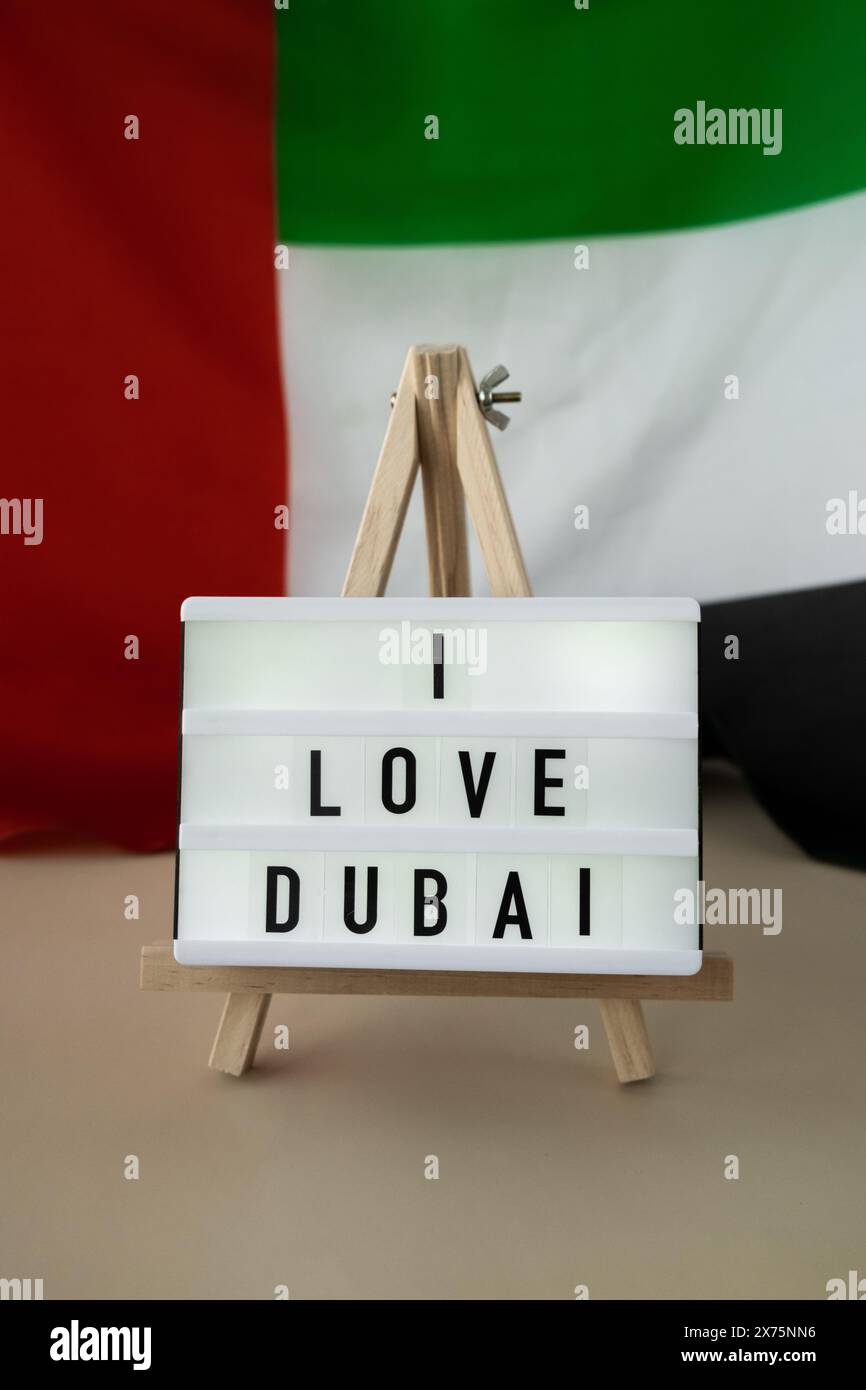 Message text I LOVE DUBAI on background of waving UAE flag made from ...