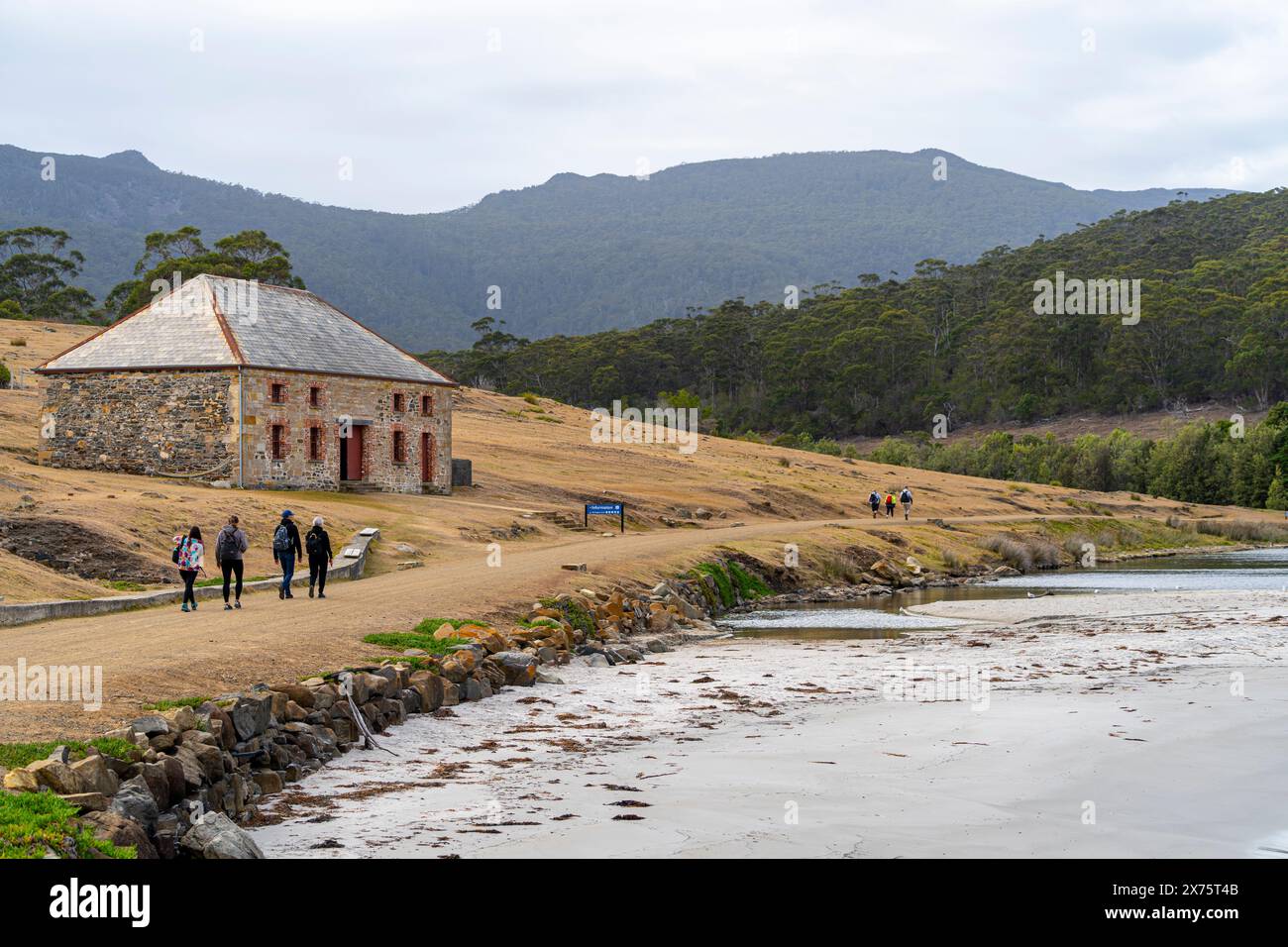 Four people walking past Commissariat Store now an Information Centre ...