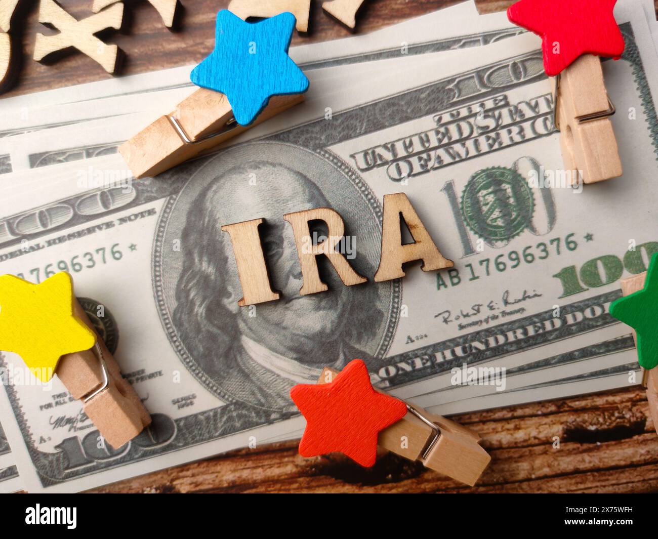 Top view wooden word and banknotes with text IRA on a wooden background ...