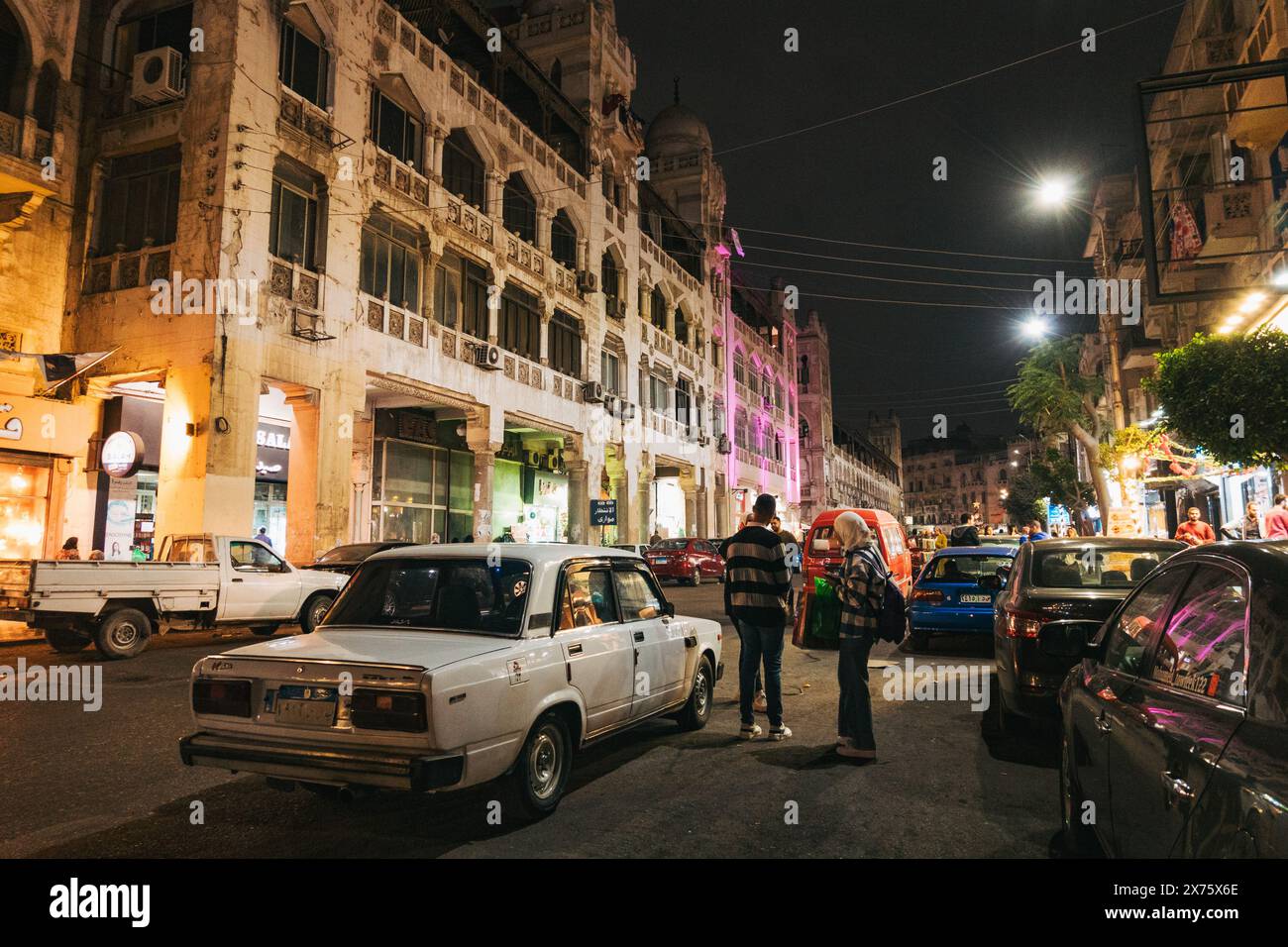 Night street scene in Heliopolis, Cairo, with a vintage Lada parked ...
