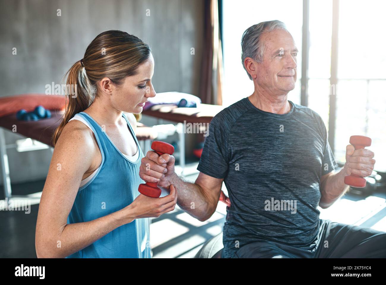 Dumbbell, fitness and senior man with personal trainer in physiotherapy ...