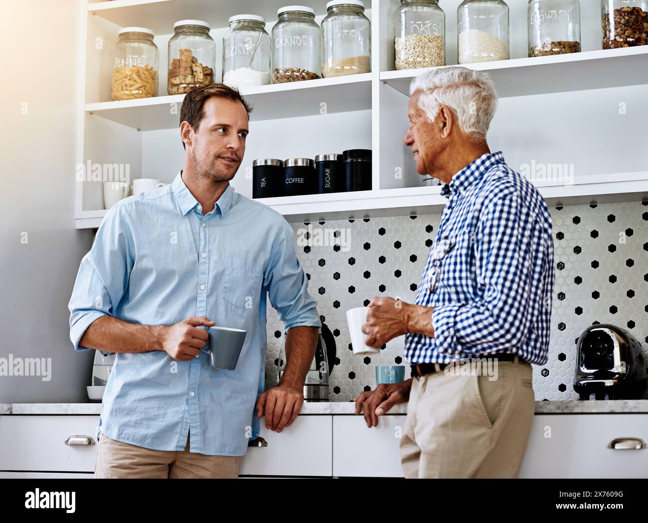 Man, advice and senior father in kitchen with conversation in morning ...
