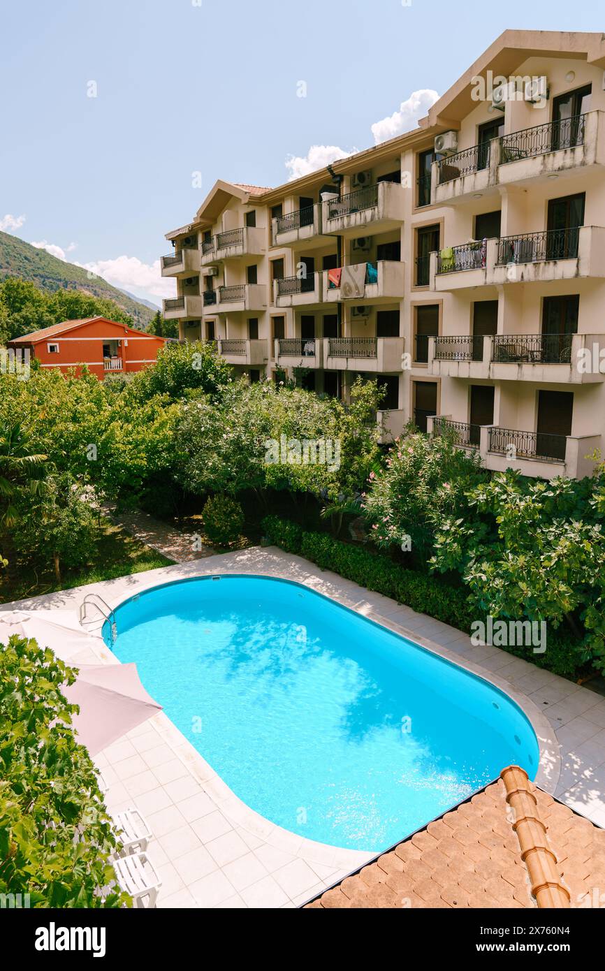 Oval swimming pool in a cozy courtyard of an apartment building in a ...