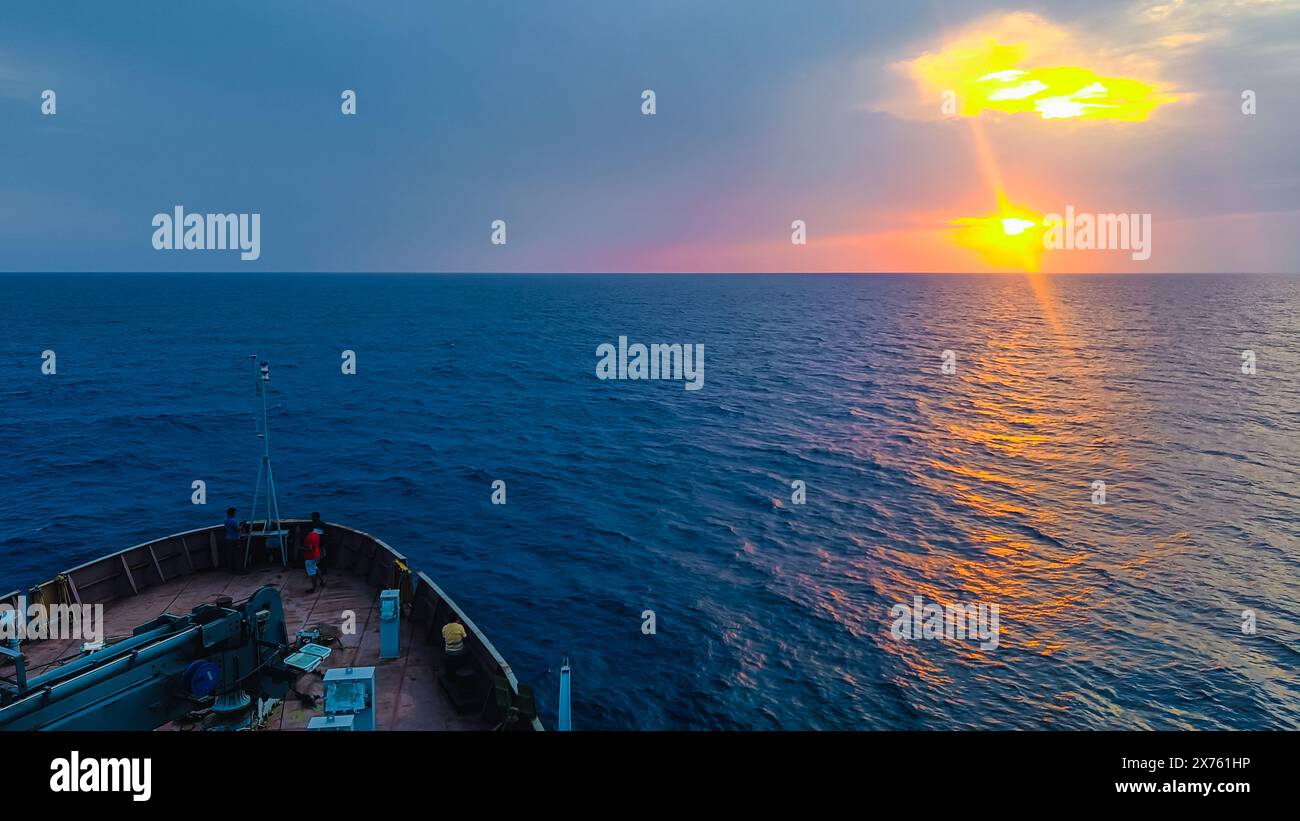 ship sailing in blue sea during sunset or sunrise. Golden light of sun ...