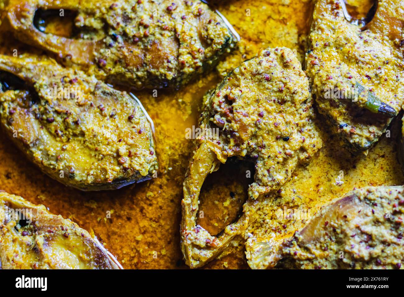 Sorshe ilish or hilsa fish curry cooked with mustard seeds served on a ...