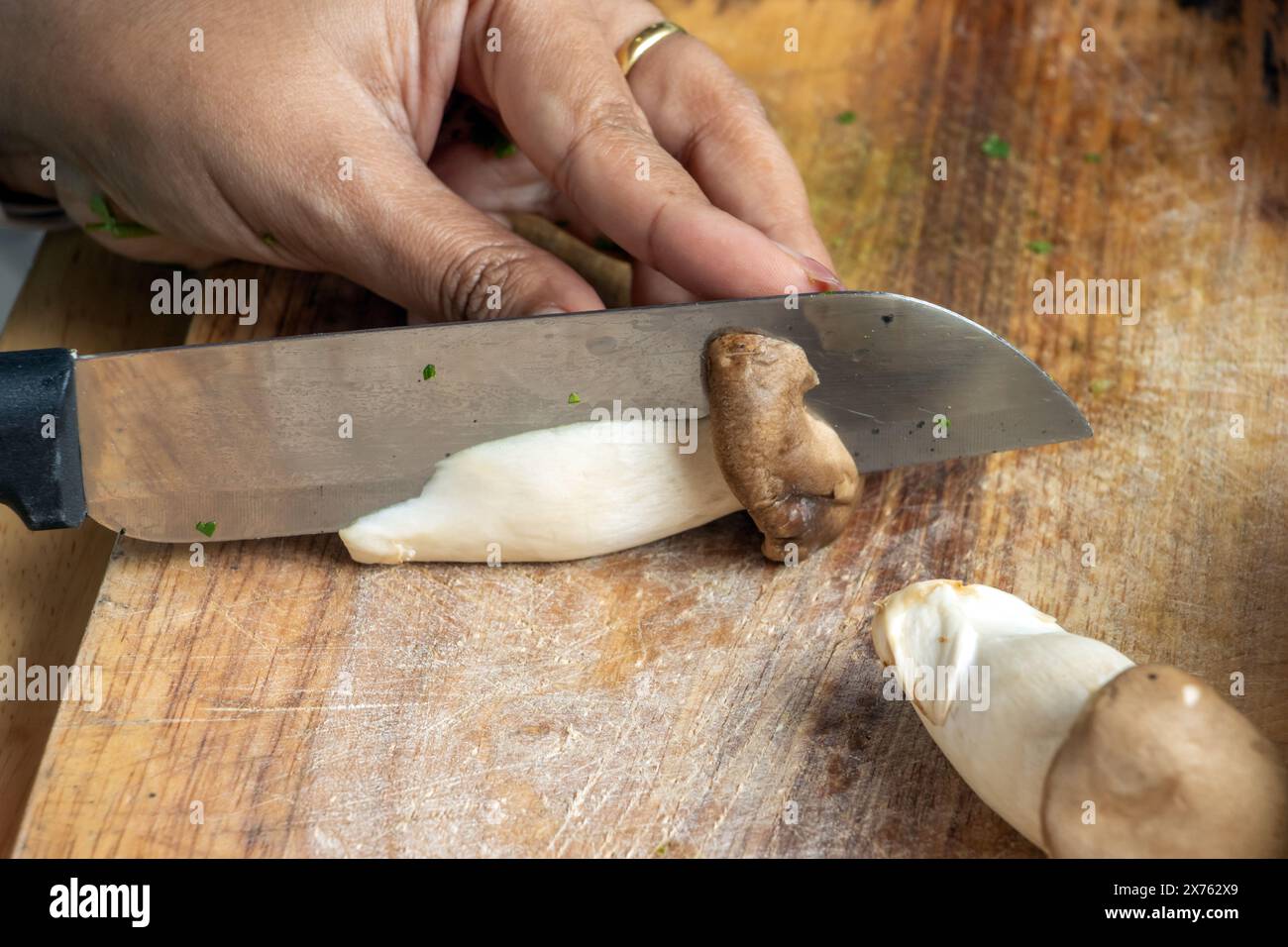 Slicing a mushroom on a kitchen cutting board Stock Photo - Alamy