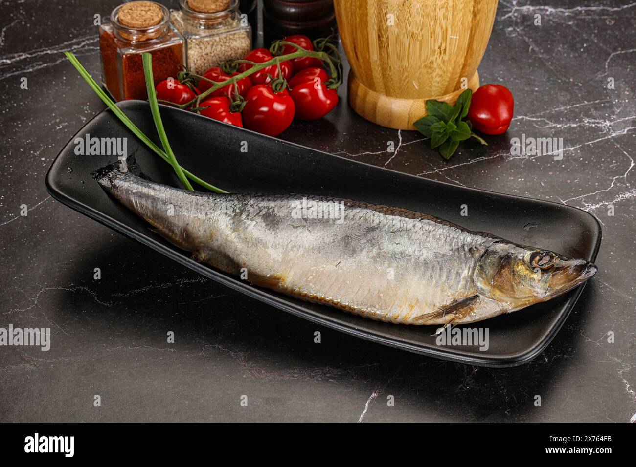 Whole raw salted herring fish in the plate Stock Photo - Alamy