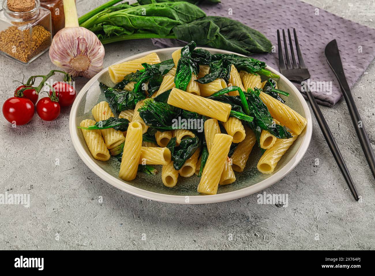 Italian cuisine - pasta tortiglioni with spinach Stock Photo - Alamy
